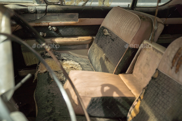 Retro car dirty and ripped seats interior Stock Photo by phoenixproduction