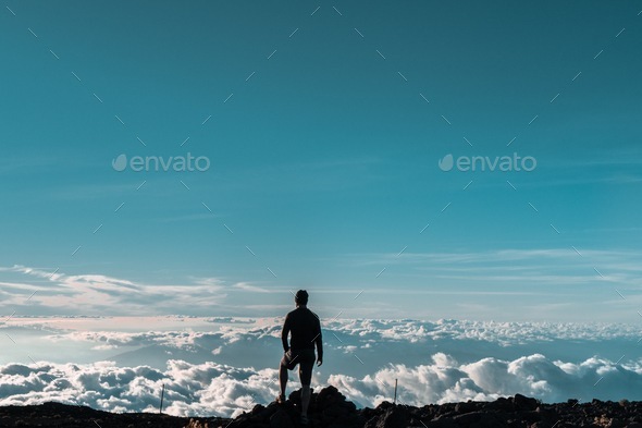 Man standing on the top of the mountain above the clouds Stock Photo by ...
