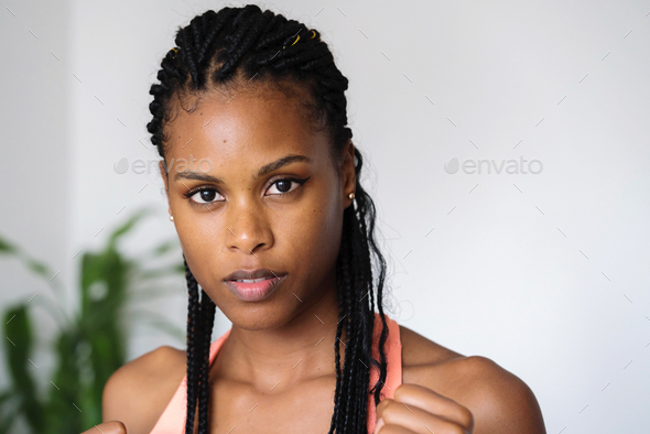 Black woman with braided hair in a boxing stance Stock Photo by ...