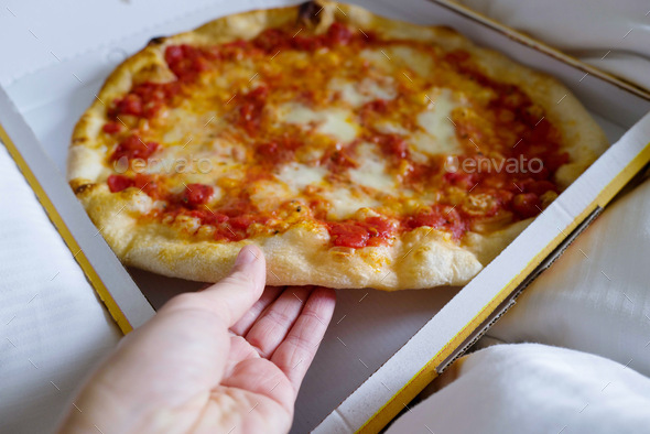 Hand holding pizza in the box Stock Photo by phoenixproduction | PhotoDune