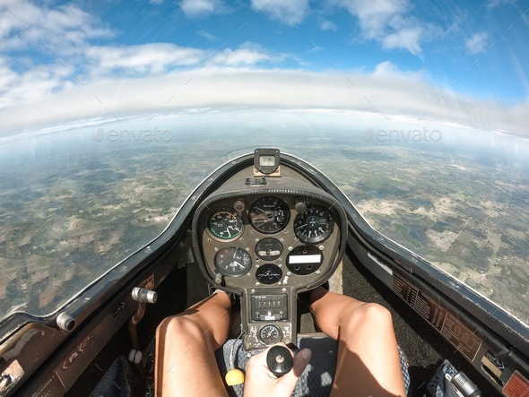 Woman piloting glider plane cockpit view Stock Photo by phoenixproduction