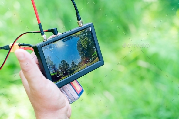 Display for monitoring the flight of a drone in male hands close-up ...