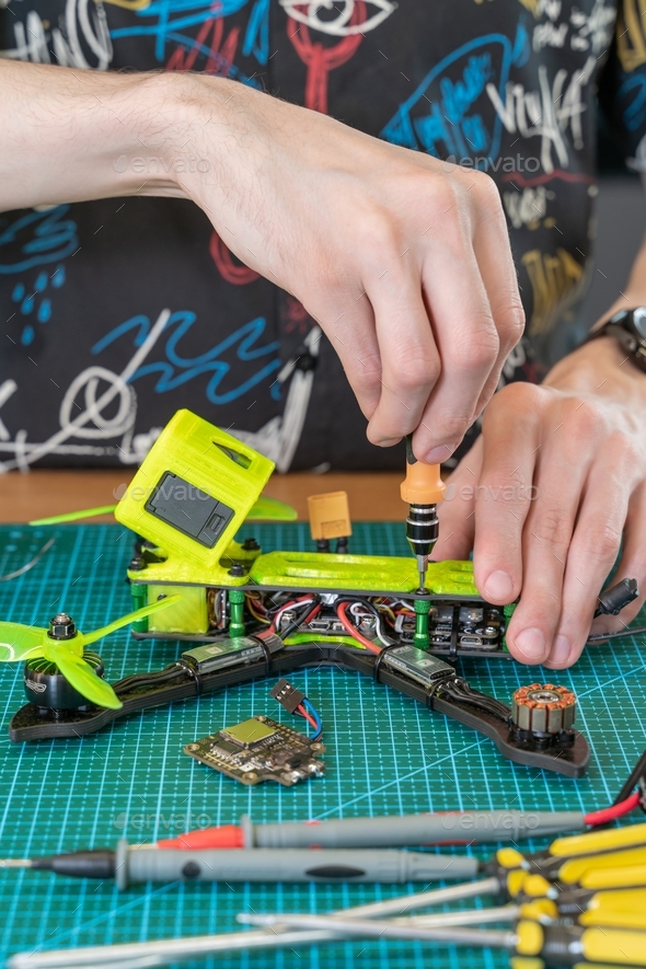 Man repairing a broken drone closeup. Small sports drone handmade ...