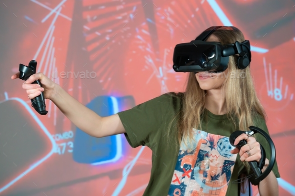 Young girl in 3D virtual reality glasses. VR glasses and helmet ...