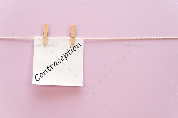 sticker with the inscription contraception hangs with a clothespin on a ...