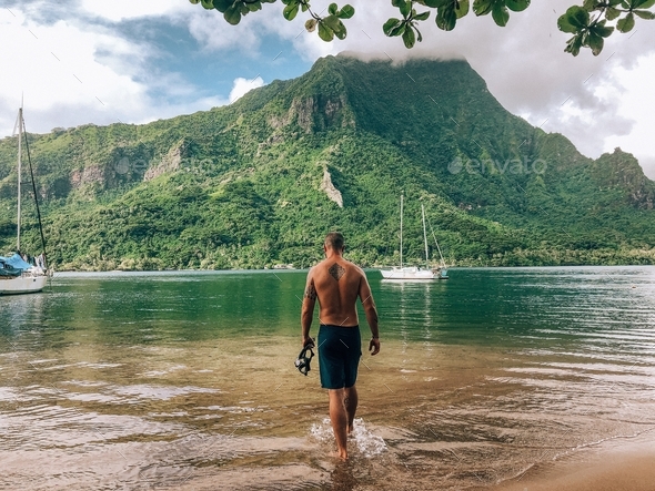 Man walking into the water with the mask and a snorkel Stock Photo by ...