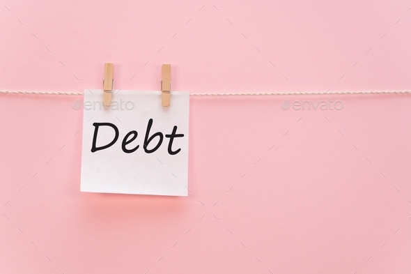 sticker with the inscription Debt hangs with a clothespin on a rope on ...