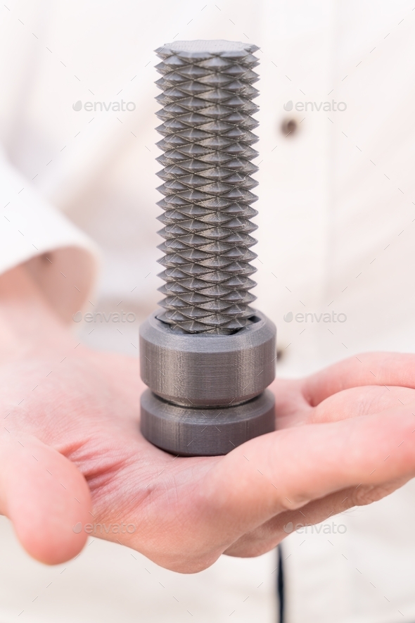 3D printed bolt with bi-directional thread in male hands close-up Stock ...
