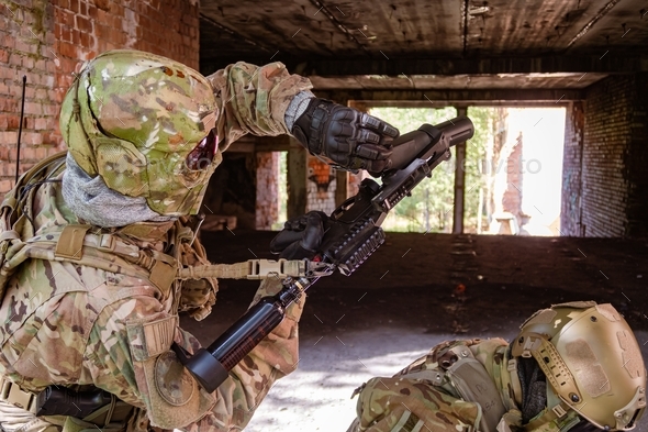 People in military uniforms with firearms are practicing combat ...