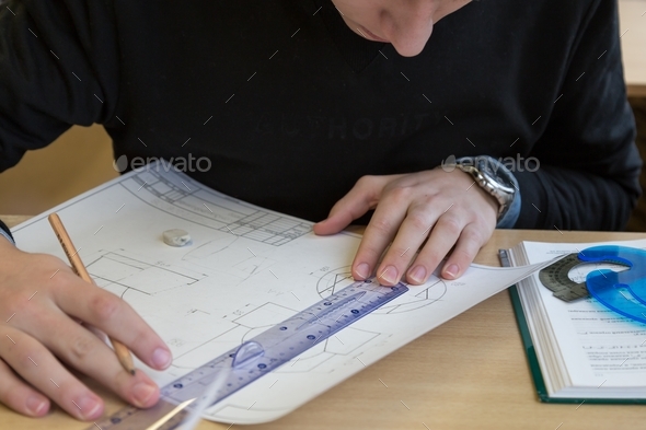 A student performs a task on engineering graphics - draws a drawing ...