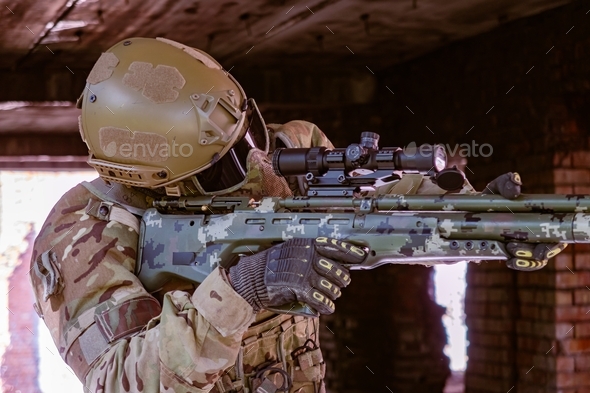 People in military uniforms with firearms are practicing combat ...