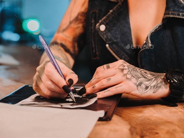 Tattoo artist drawing illustration inside ink studio Stock Photo by ...