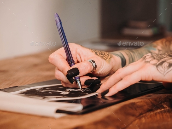 Tattoo artist drawing illustration inside ink studio Stock Photo by ...