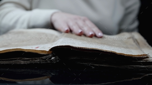 Woman flipping through pages of antique book. Lady with Bible ...