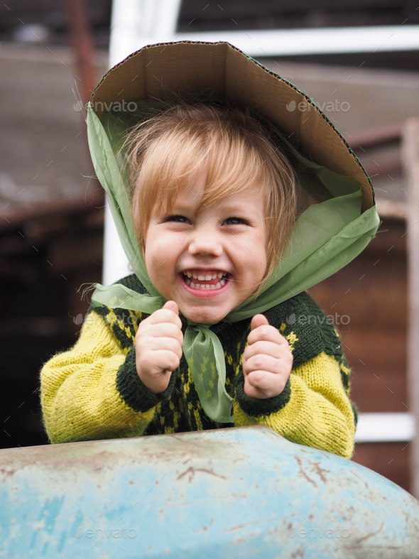Cute little blonde girl smiling into the camera, portrait of child ...
