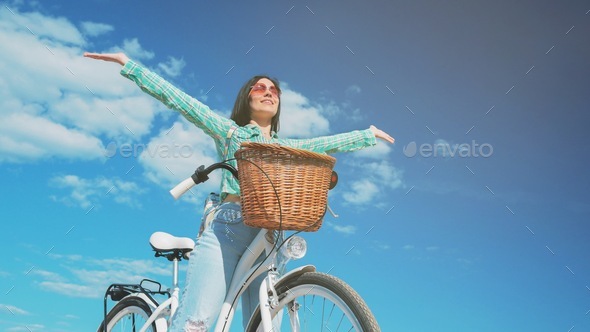 Beautiful young Lady with white retro styled bicycle. Hands up. Freedom ...