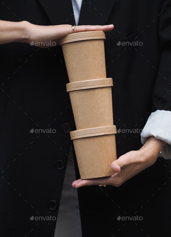 Anonymous young woman in classic black jacket holding stack food ...