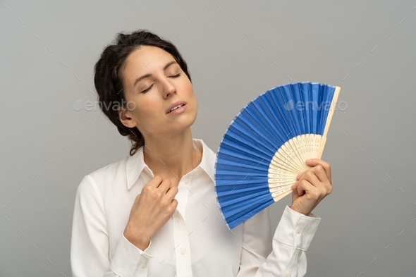 Overheated woman employee using wave fan suffer from heat sweating ...