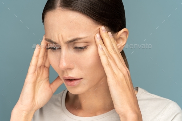 Woman feeling headache, weakness, massaging temples, tired, exhausted ...