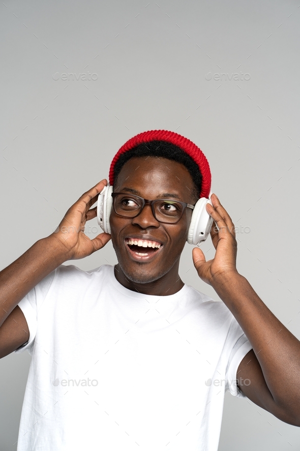 Happy Black man wear headphones enjoying listening to new album ...