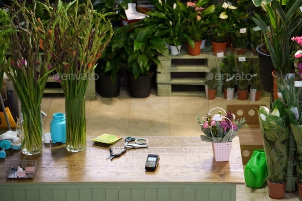Workspace of florist: table with scissors to create bouquets inside ...