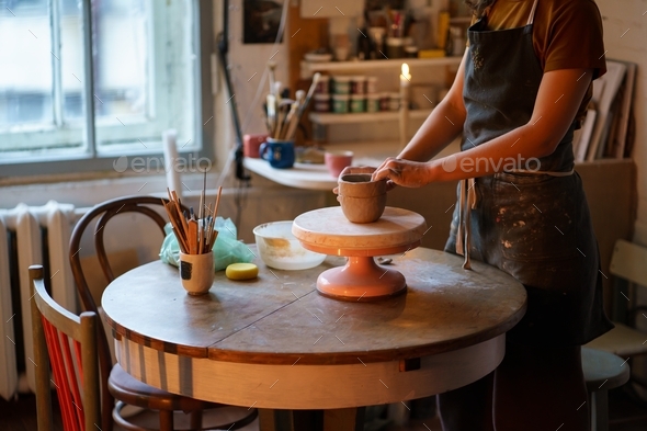 Pottery class student girl shaping vase in studio. Woman artisan ...
