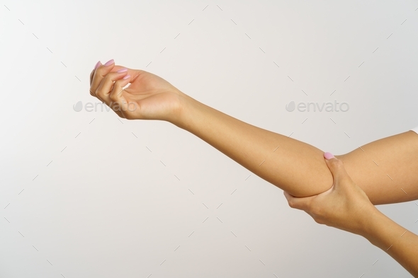 Woman with injured arm touching elbow. African girl with pain in hand ...