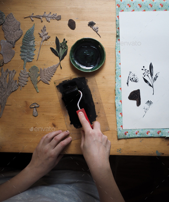Linocut artist at work in art studio, top view. Stock Photo by ...
