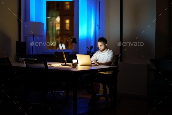 Ambitious workaholic businessman stay in office overtime busy with ...