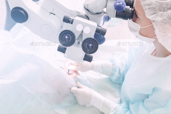 Surgeon performing an eye surgery under the microscope. Eyesight ...