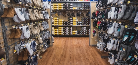 Shoe aisle in store, lots of shoes on racks Stock Photo by rohaneh