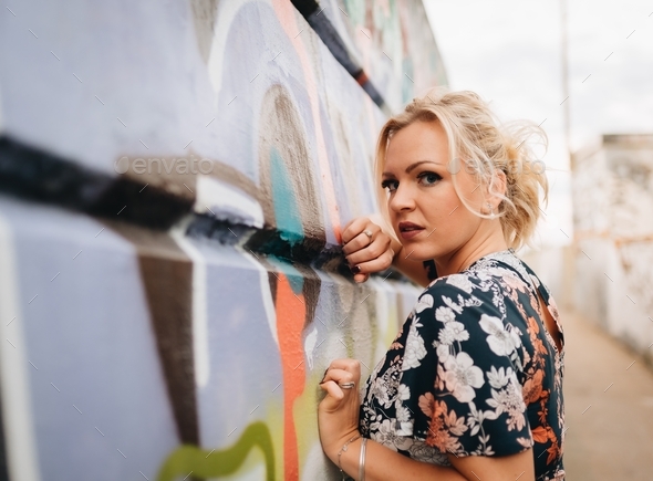 Young millennial girl in city posing for portrait at sunset Stock Photo ...