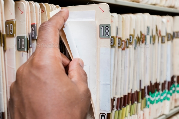 Medical records, charts, African American man sorting through patient ...