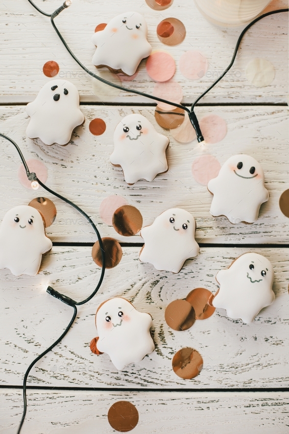 Halloween cute scary ghost cookies on white wooden table. Trick or ...