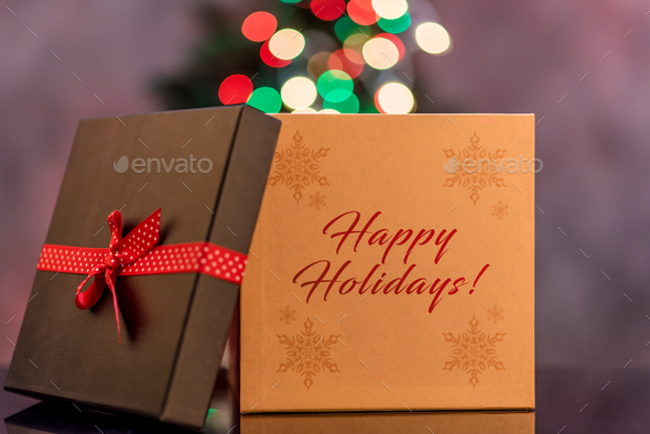 Happy holidays box, box with Christmas lights in background Stock Photo ...