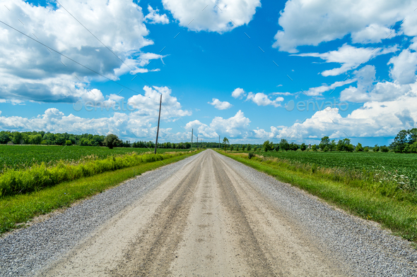 Open road, greenery and blue sky with clouds Stock Photo by rohaneh