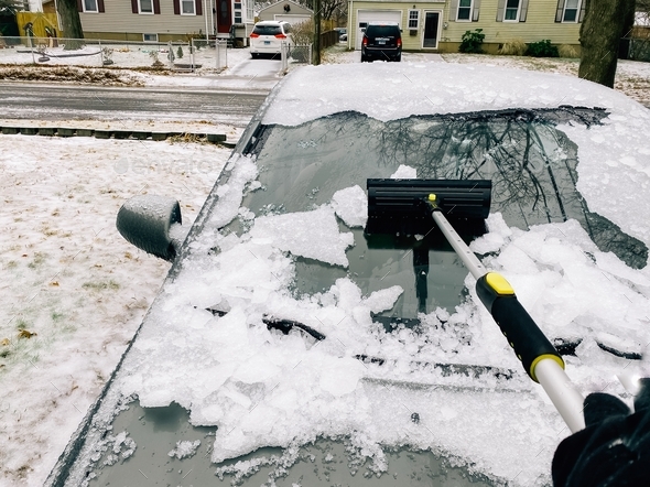 Man scraping snow and ice off car window after blizzard Stock Photo by ...
