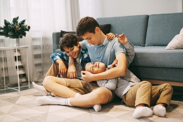 Three teenage brothers play and frolic at home on weekends. Friends ...