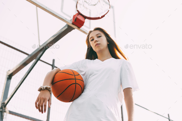 Portrait of young female basketball player. Beautiful teen girl playing ...