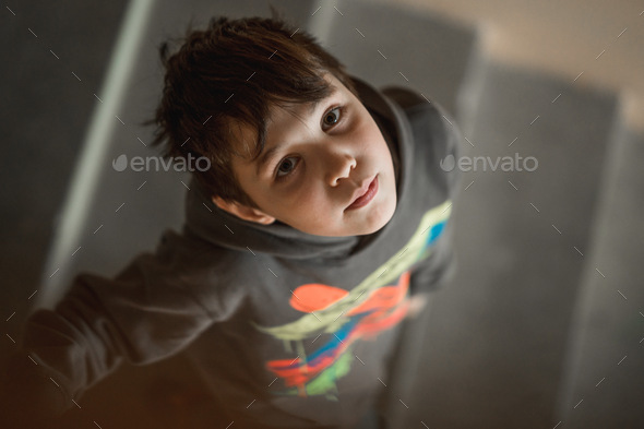 A brooding teenage boy in the entrance on the stairs Stock Photo by ...