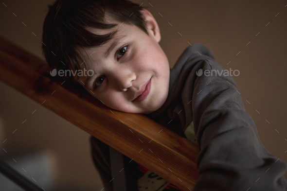 A brooding teenage boy in the entrance on the stairs Stock Photo by ...