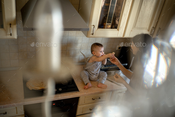 Mom and baby fry pancakes at home in the kitchen. Top view Stock Photo ...