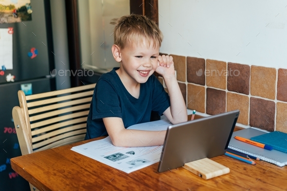 boy school student studying remotely at home using electronic ...