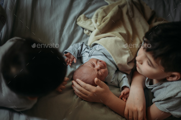 older brothers look after newborn brother Stock Photo by nastuffa ...