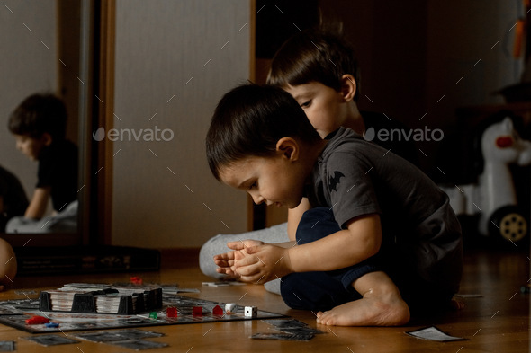 Boys, brothers play a board game. Children play monopoly Stock Photo by ...