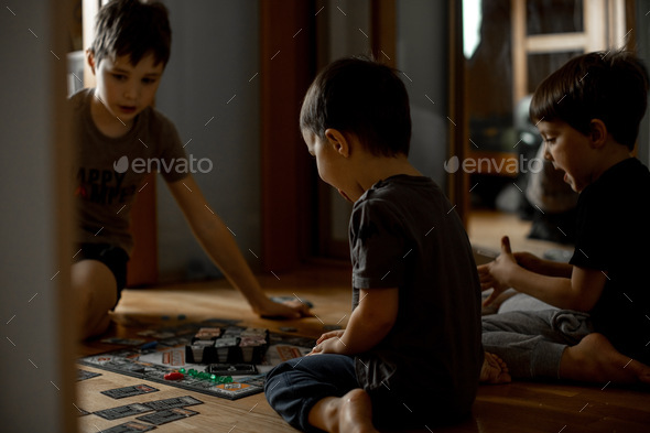Boys, brothers play a board game. Children play monopoly Stock Photo by ...