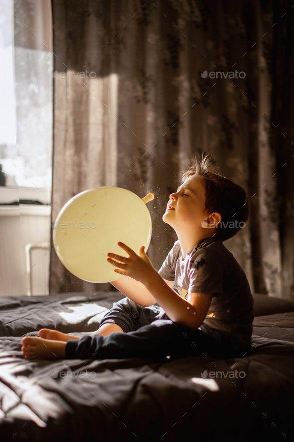 The boy is inflating a balloon Stock Photo by nastuffa | PhotoDune