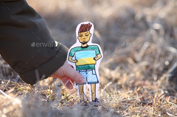 A small refugee boy from Ukraine with a drawing of the Ukrainian flag ...