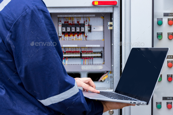 Electrical engineer working in control room. Stock Photo by kckate16