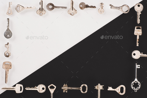 top view of different vintage keys frame over black and white ...